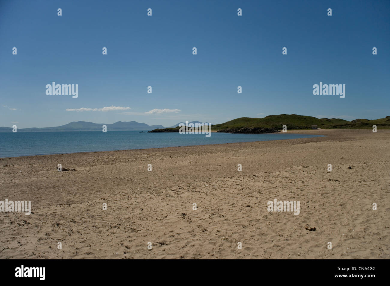 Llanddwyn island and lighthouse from the beach at Traeth Llanddwyn on ...