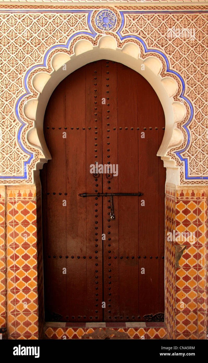 Traditional, decorated wooden keyhole door with stucco & tilework ...