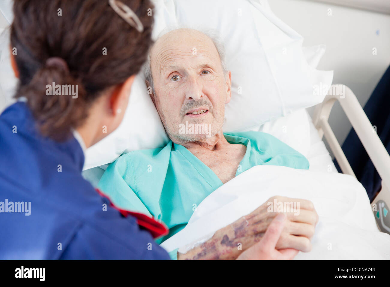 An elderly male patient being comforted by a nurse UK Stock Photo - Alamy