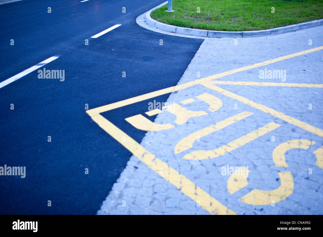 Bus stop sign on the road Stock Photo - Alamy