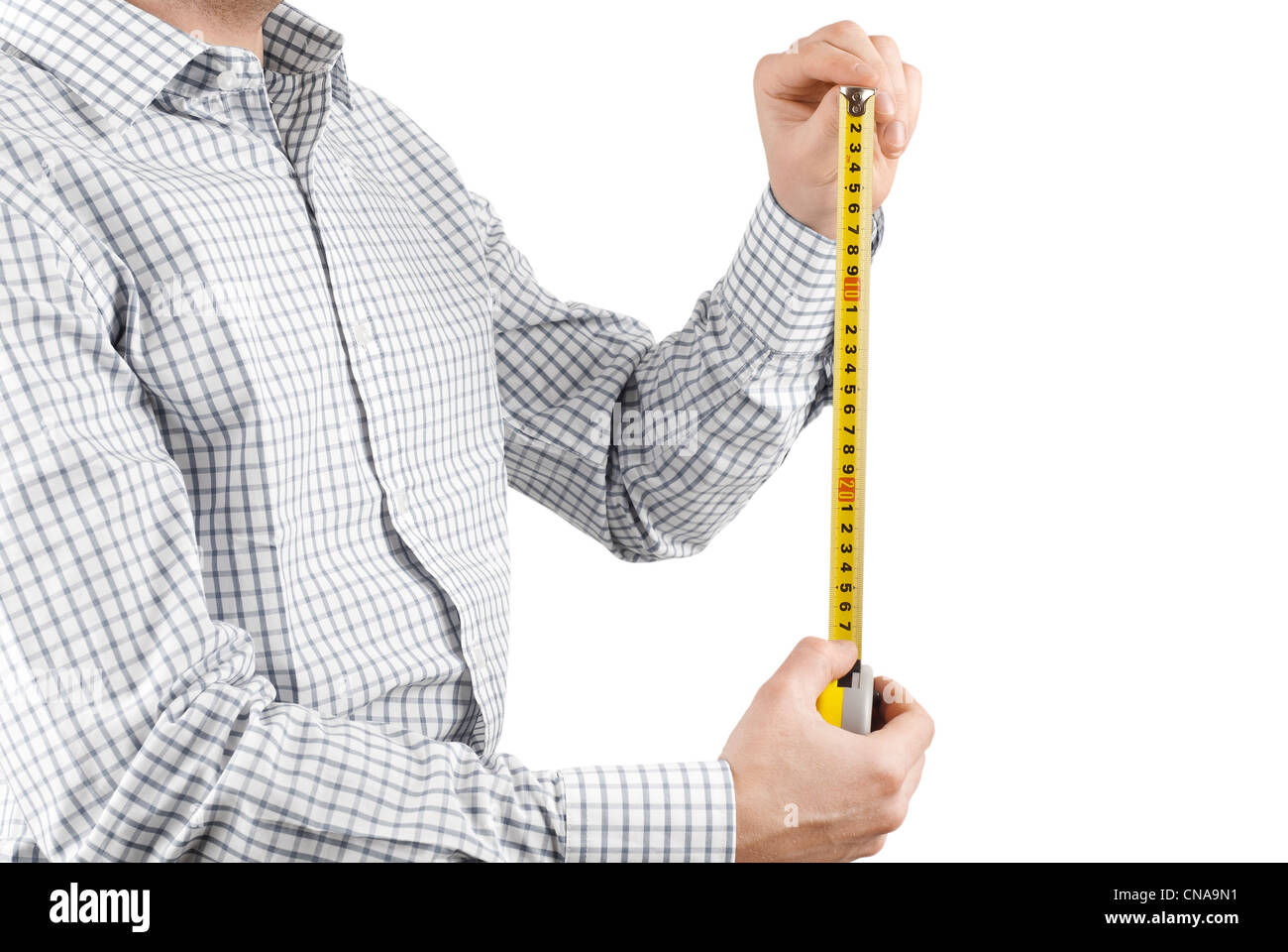 Man with yellow tape measuring something Stock Photo - Alamy