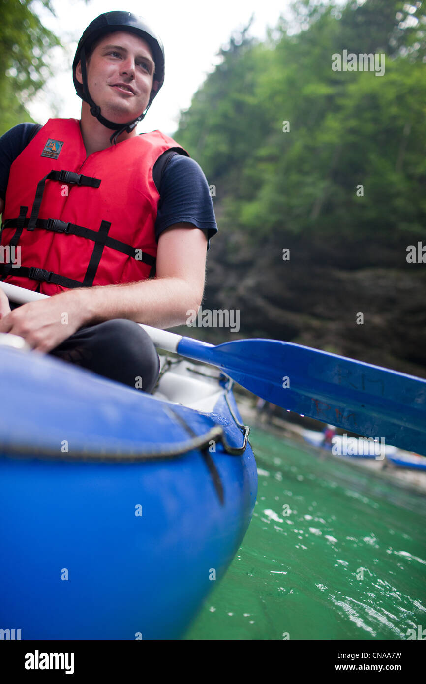 White water rafting - handsome young man in a boat during a halt Stock ...