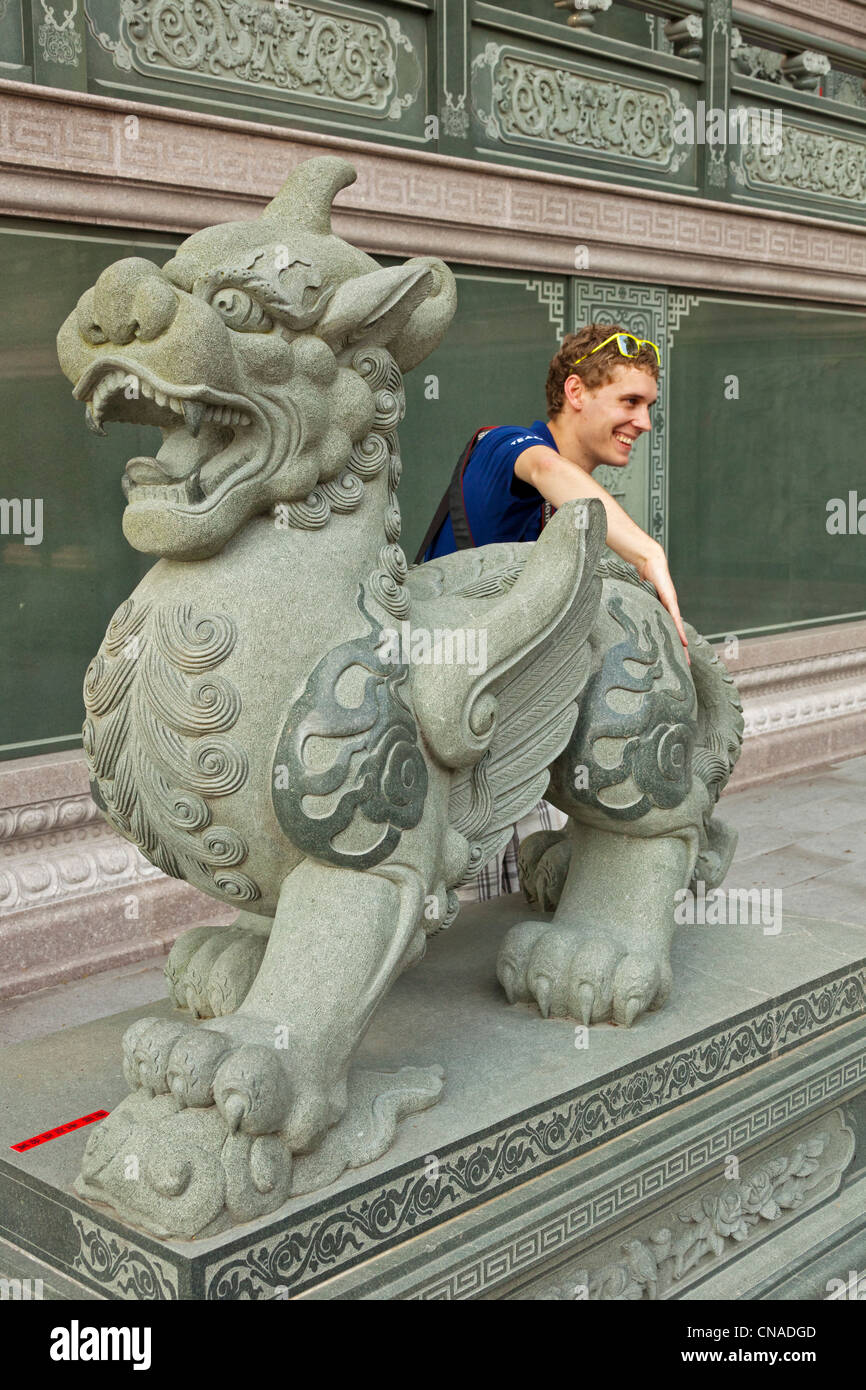 Patting a stone lion for good luck at Wenwu Temple, Sun Moon Lake ...
