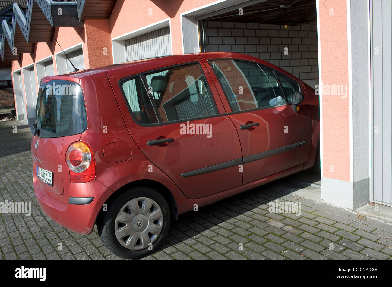 Renault Modus car reversing out of a residential garage Stock Photo - Alamy