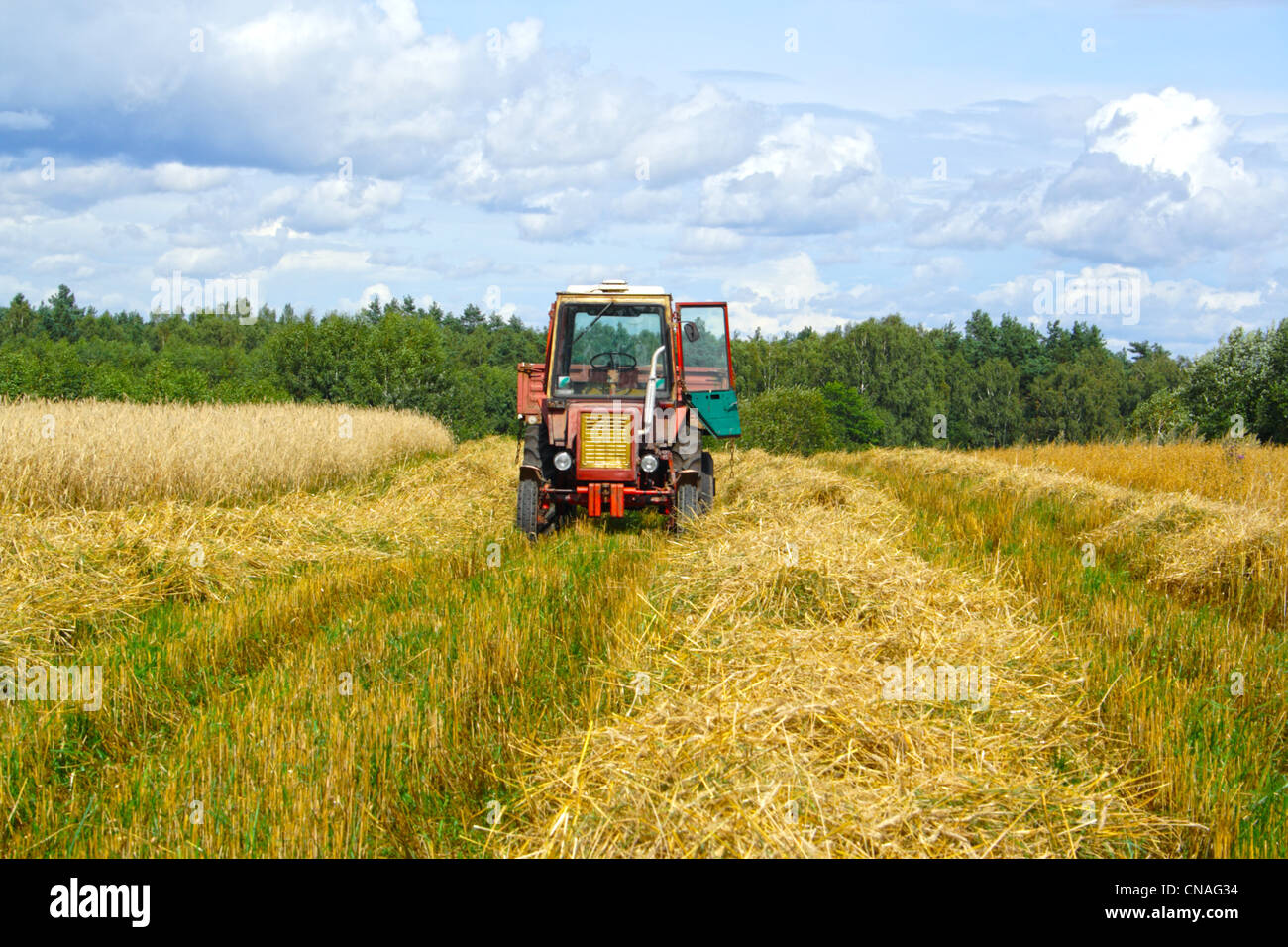 the old tractor during work on field Stock Photo - Alamy