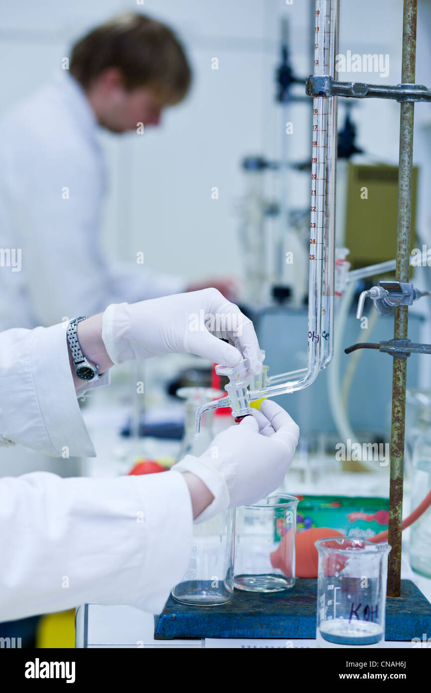 female researcher carrying out research in a chemistry lab (color toned ...