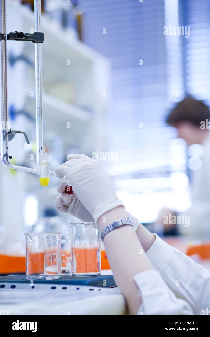 female researcher carrying out research in a chemistry lab (color toned ...