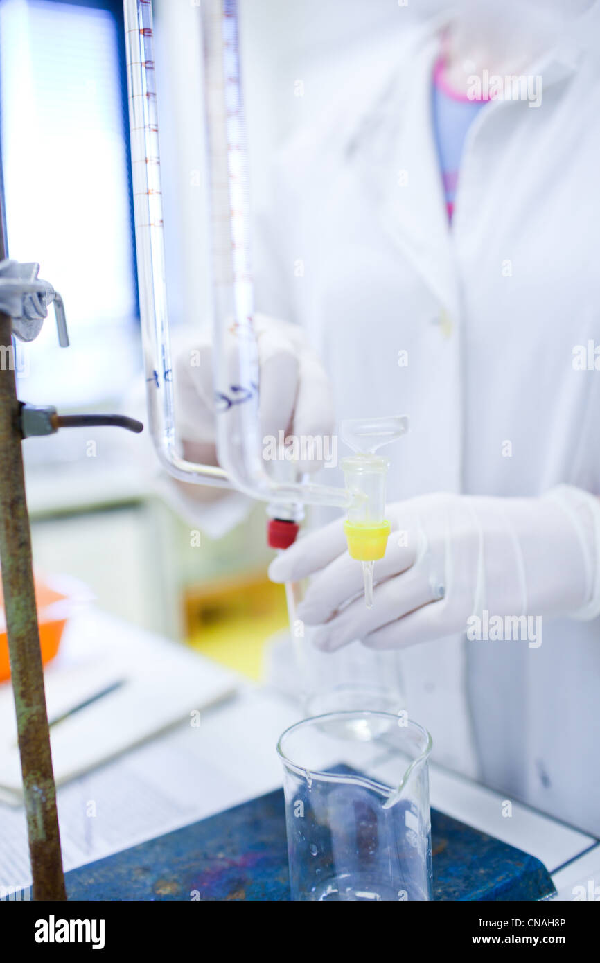 female researcher carrying out research in a chemistry lab (color toned ...