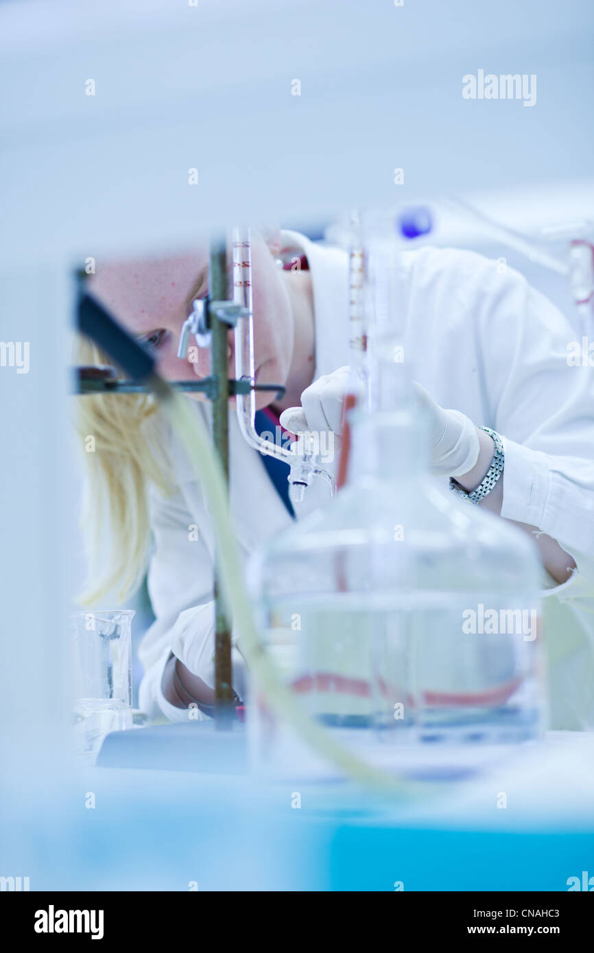 portrait of a female researcher carrying out research in a chemistry ...