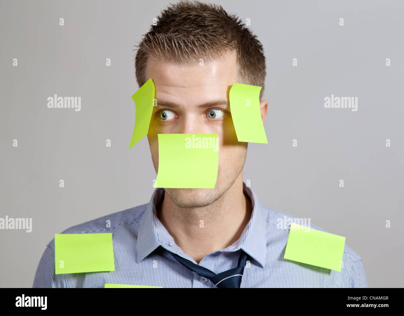 Confused businessman with post it notes on face and clothes Stock Photo ...
