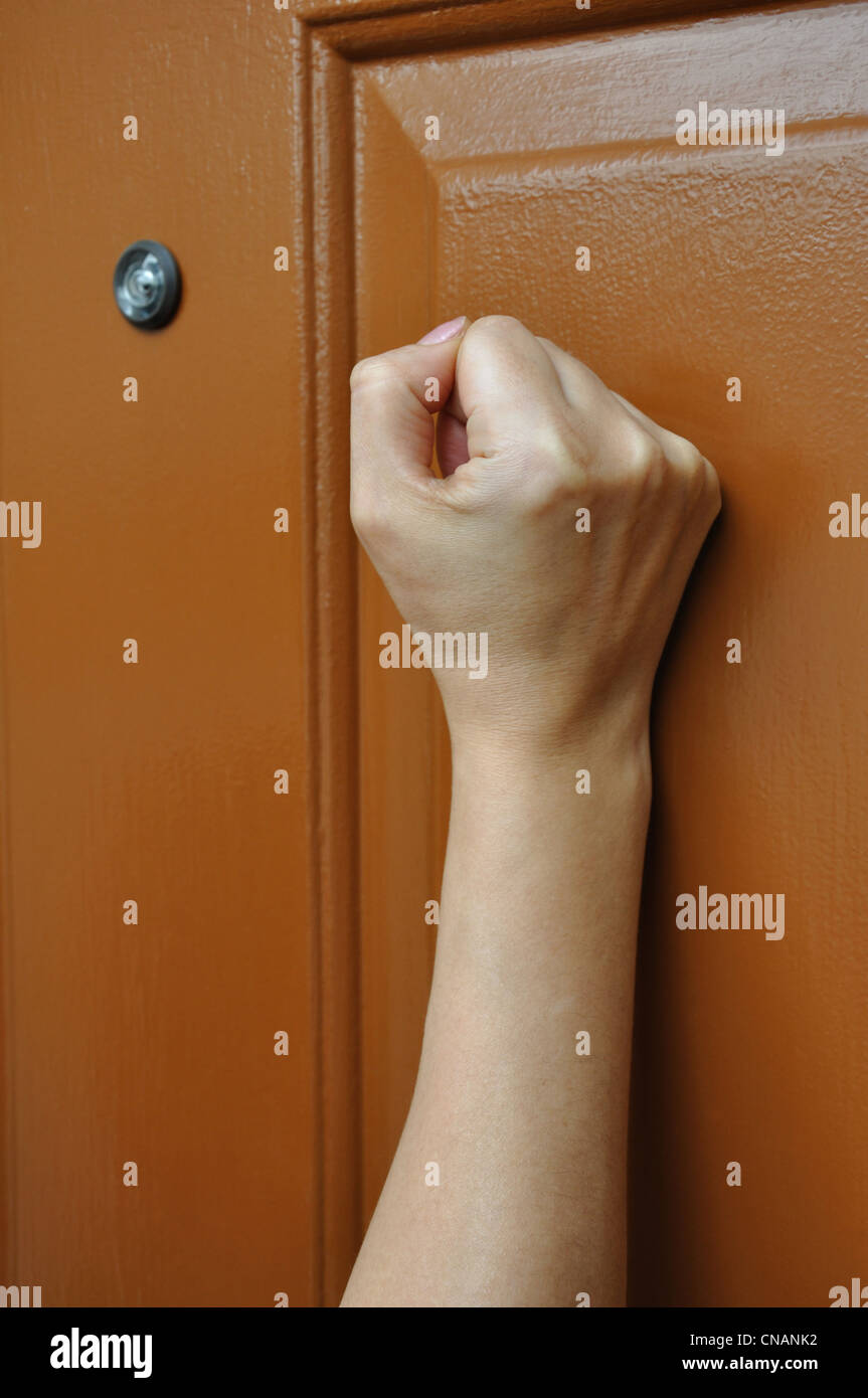 Hand knocking on the door Stock Photo - Alamy