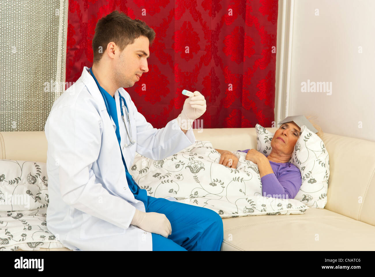 Doctor checking temperature to sick senior home Stock Photo - Alamy
