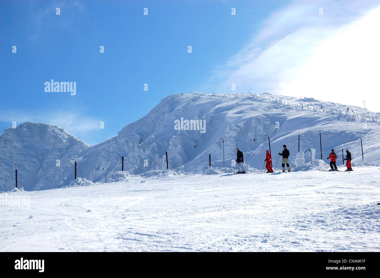 Skiers on a slope and view on Chopok peak in Jasna Low Tatras. Slovakia ...