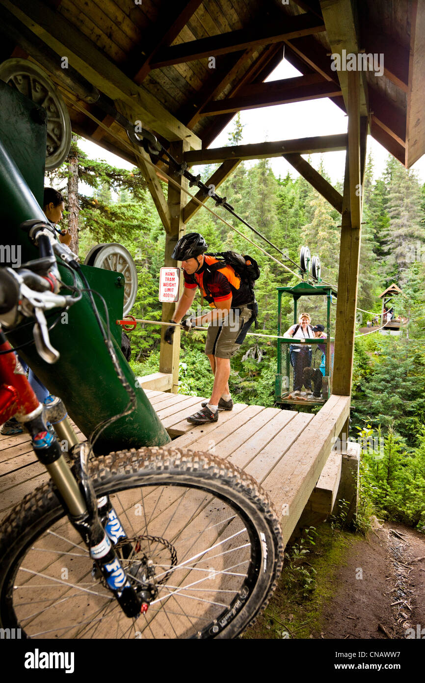 Mountain Bikers getting ready to take the hand tram across Winner Creek ...
