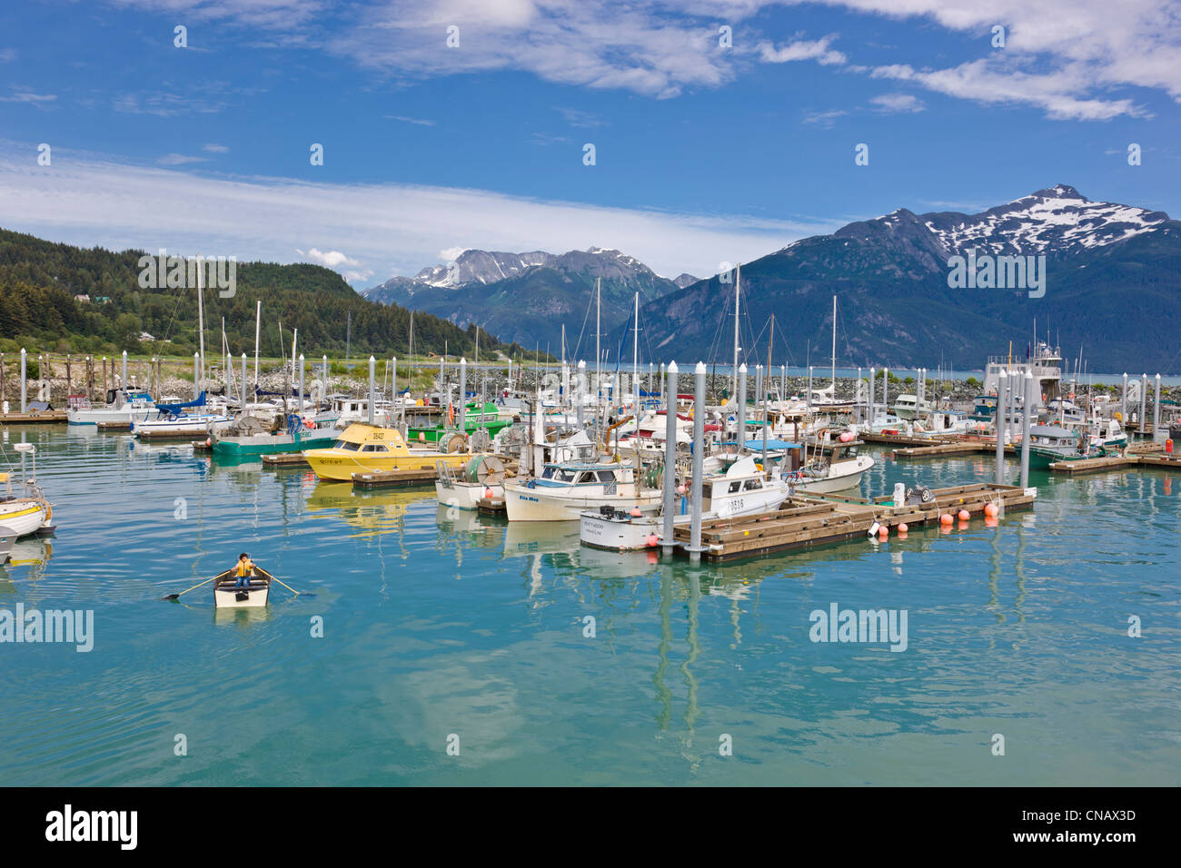 Children rowing a small dingy in tthe Haines Small Boat Harbor next to ...