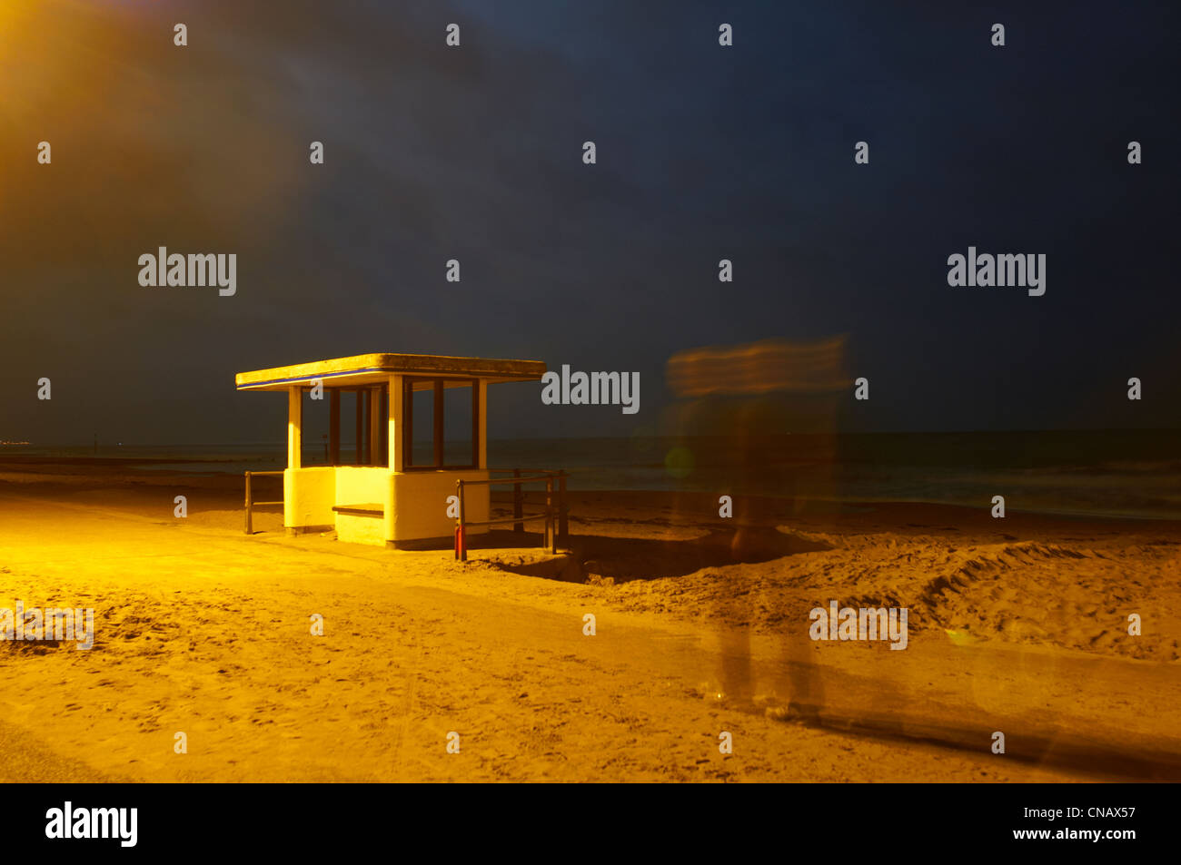Time lapse view of man on beach at night Stock Photo - Alamy