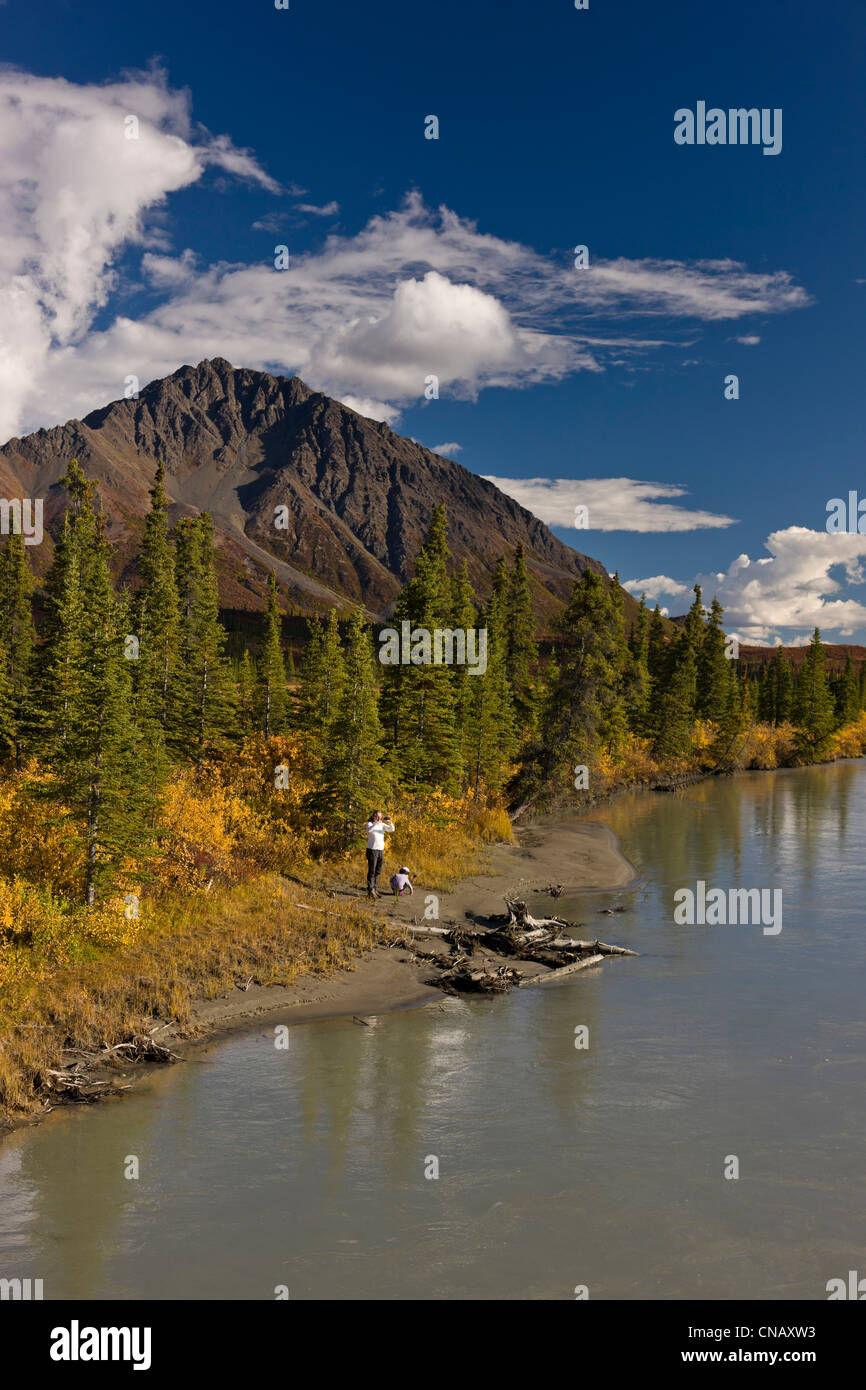 Mother and young daughter explore the bank along the Susitna River ...