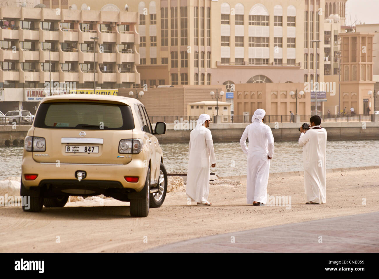 Three men in traditional dress with their Nissan Patrol 4WD car taking ...