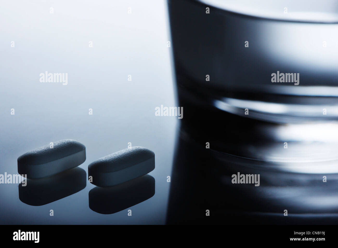 Close up of pills on reflective surface Stock Photo - Alamy