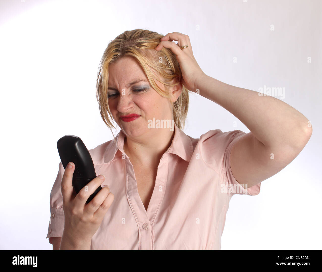 portrait of a lady holding her hands against her head in frustration ...
