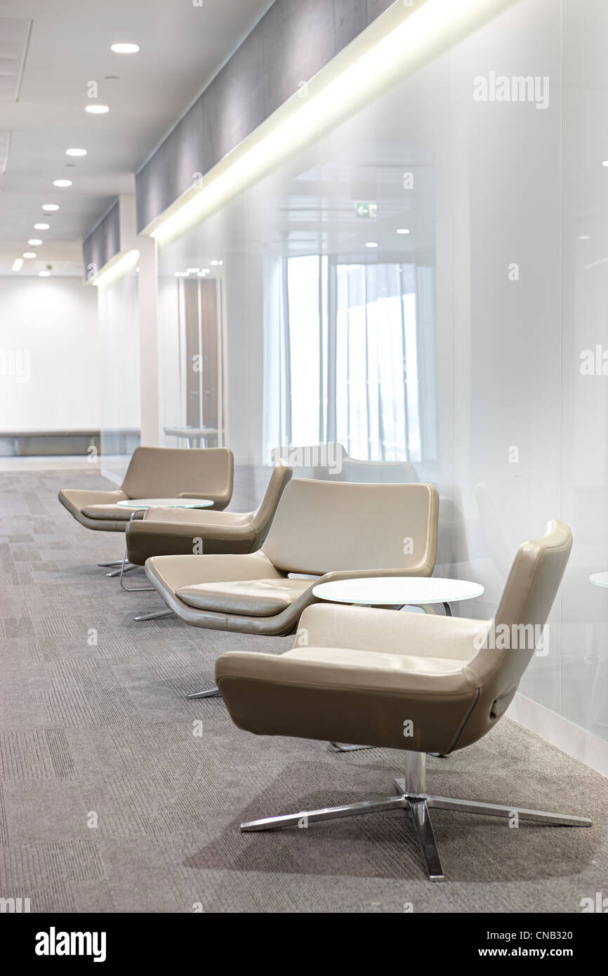 white glass wall beige chairs corridor city office Stock Photo - Alamy