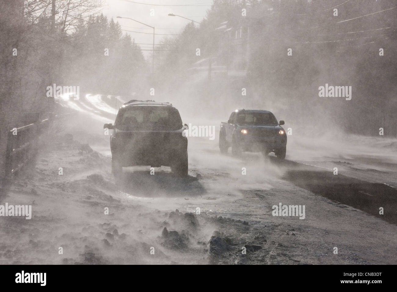 Vehicles drive on Douglas Roadway obscured by 70 mph blowing wind and ...