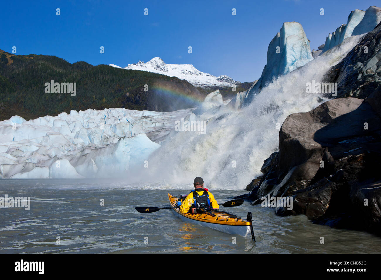 Sea kayaker on Mendenhall Lake with Mendenhall Glacier and Nugget Falls ...