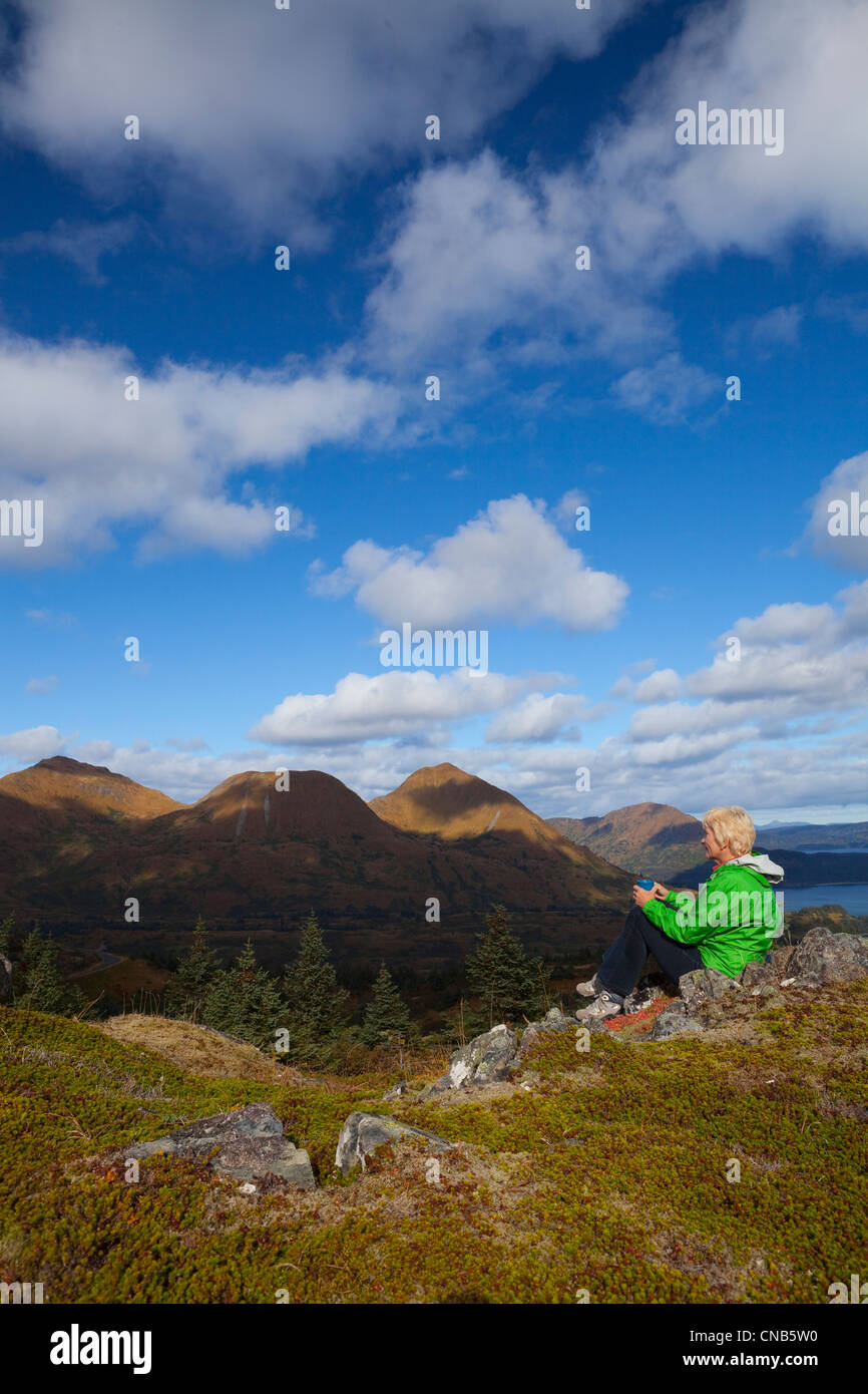 Mature woman relaxes and enjoys a hot drink on Pillar Mountain with ...