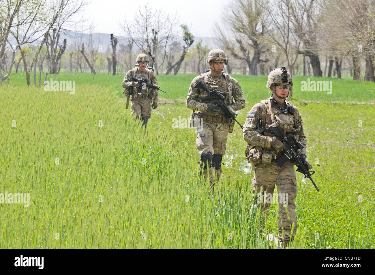 US Army soldiers patrol a field near the village March 30, 2012 in ...