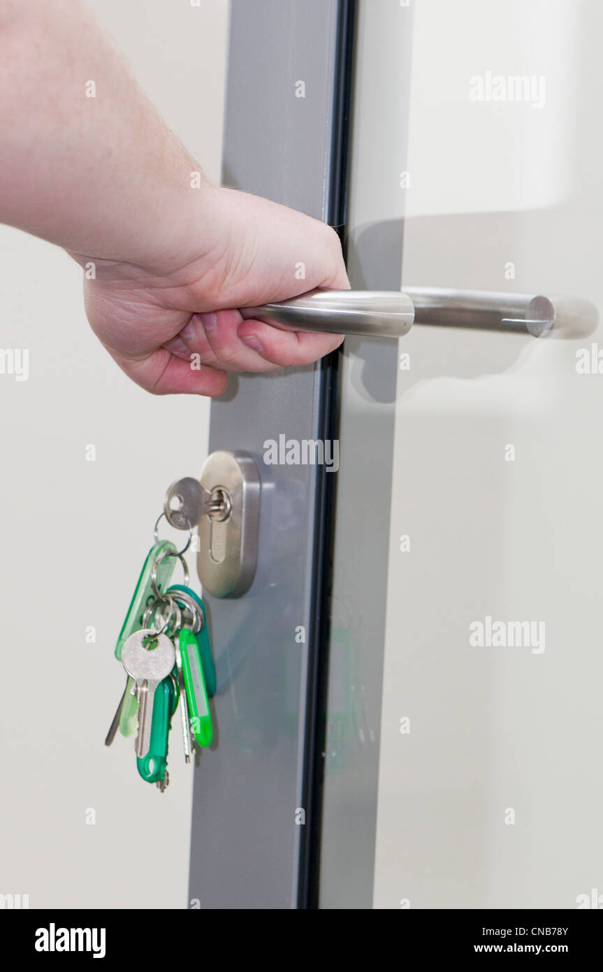 human hand on the door handle, keys in the lock doors Stock Photo - Alamy