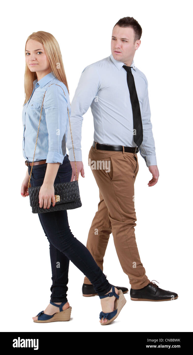 A man passing by a walking woman and casting a sly glance at her Stock ...