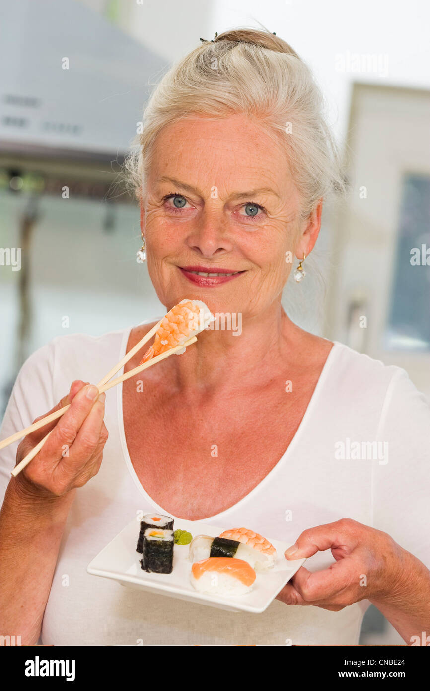 Senior woman eating fish hi-res stock photography and images - Alamy