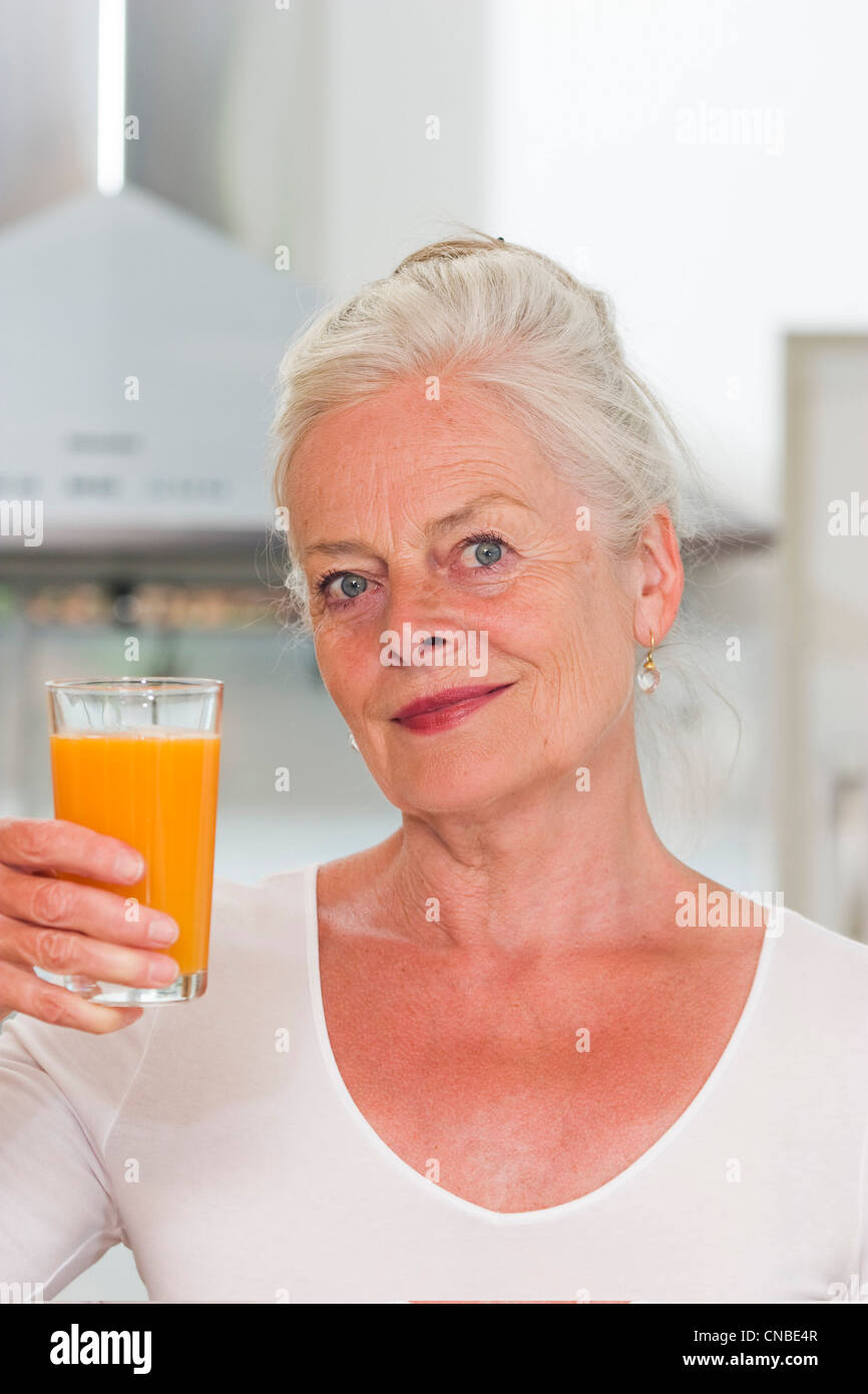 Elderly woman drinking fruit juice hi-res stock photography and images ...