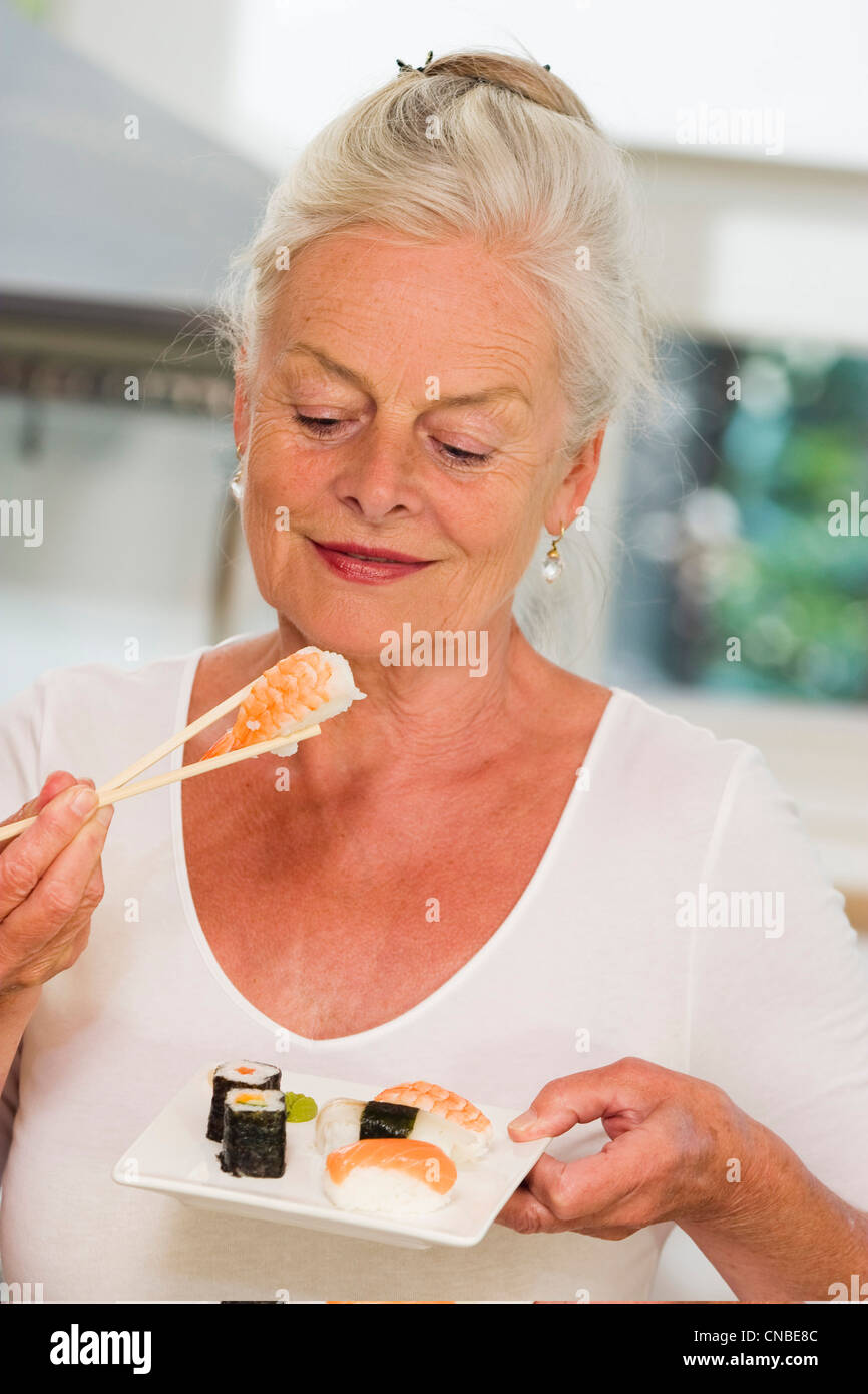 Senior woman eating fish hi-res stock photography and images - Alamy