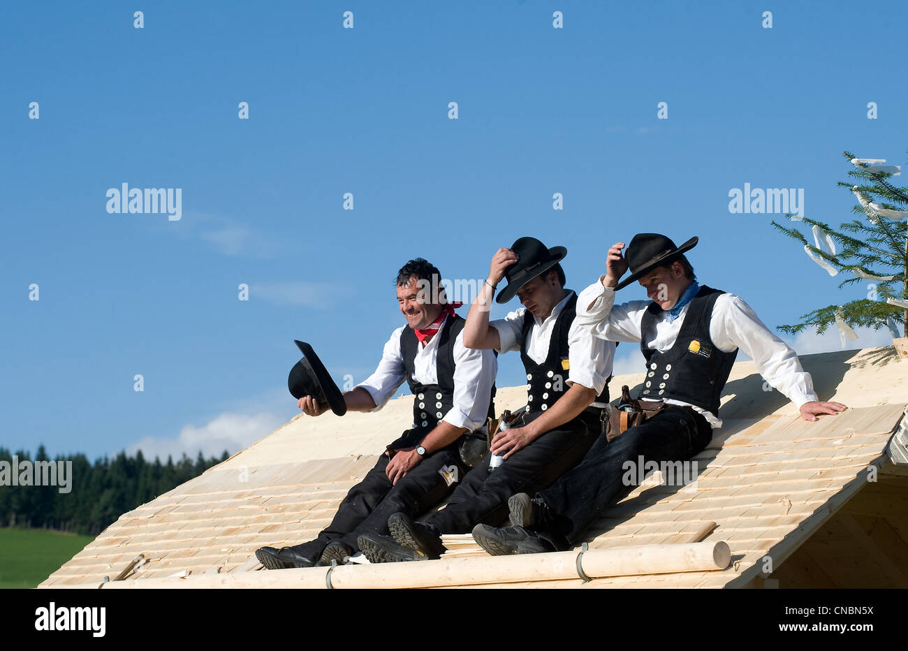 Carpenters sitting on a roof, drinking beer on the Rosstag day, St ...