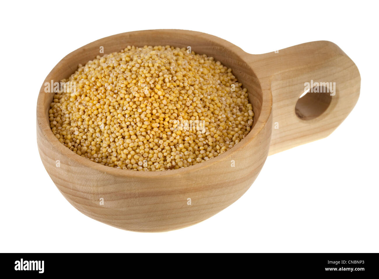 hulled millet grain on a rustic, wooden scoop or bowl, isolated on ...