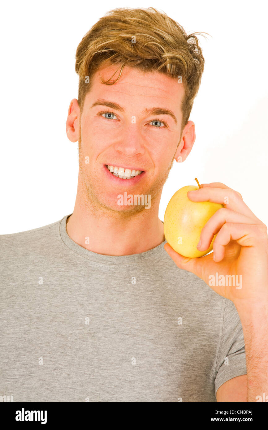 young man holding an apple Stock Photo - Alamy