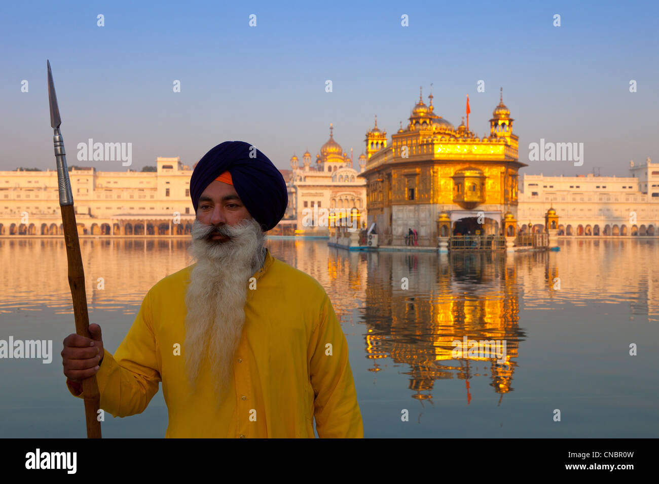 India, Punjab, Amritsar, Golden Temple and Sikh guard at sunrise Stock ...