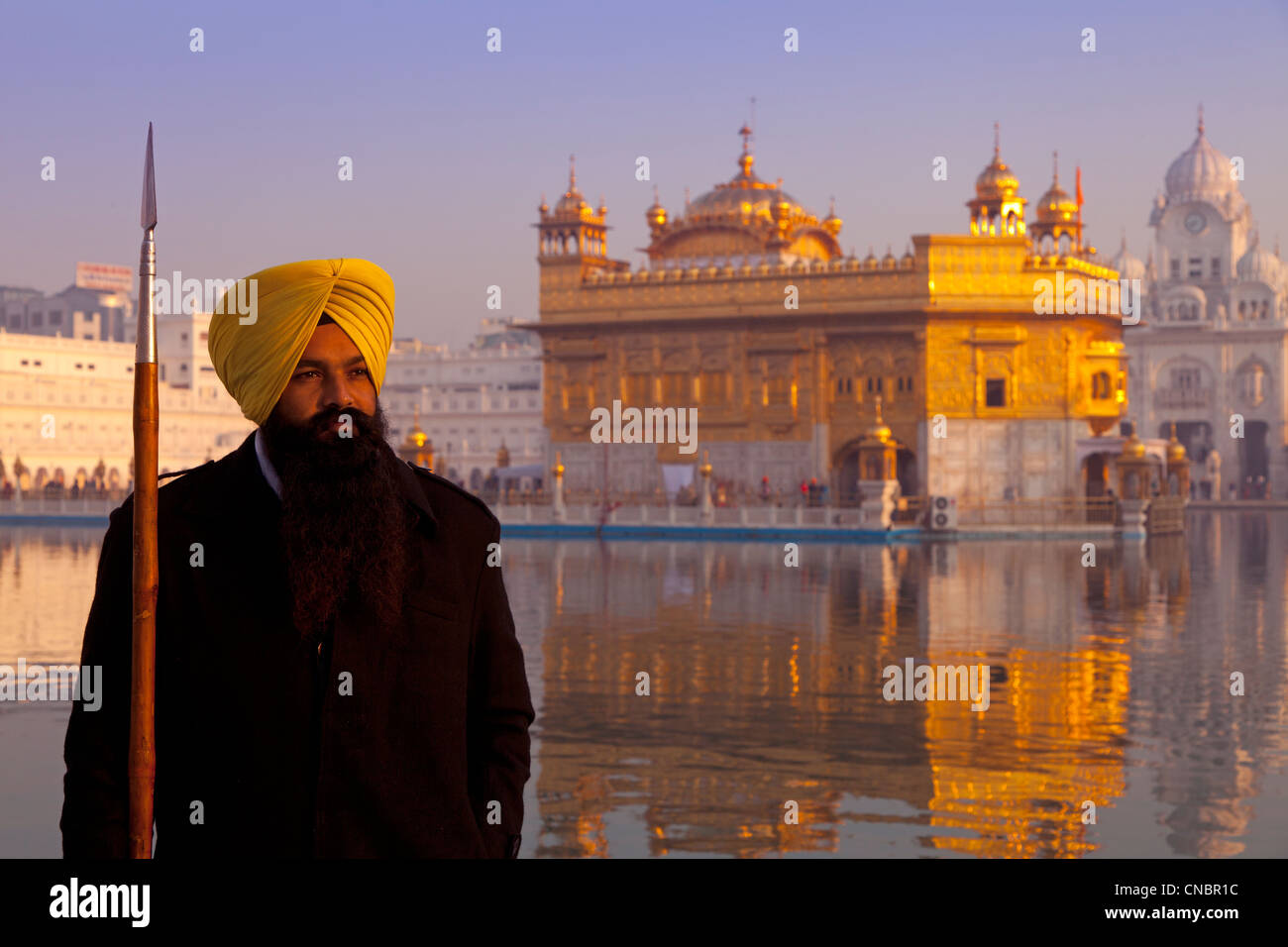 India, Punjab, Amritsar, Golden Temple and Sikh guard at sunrise Stock ...