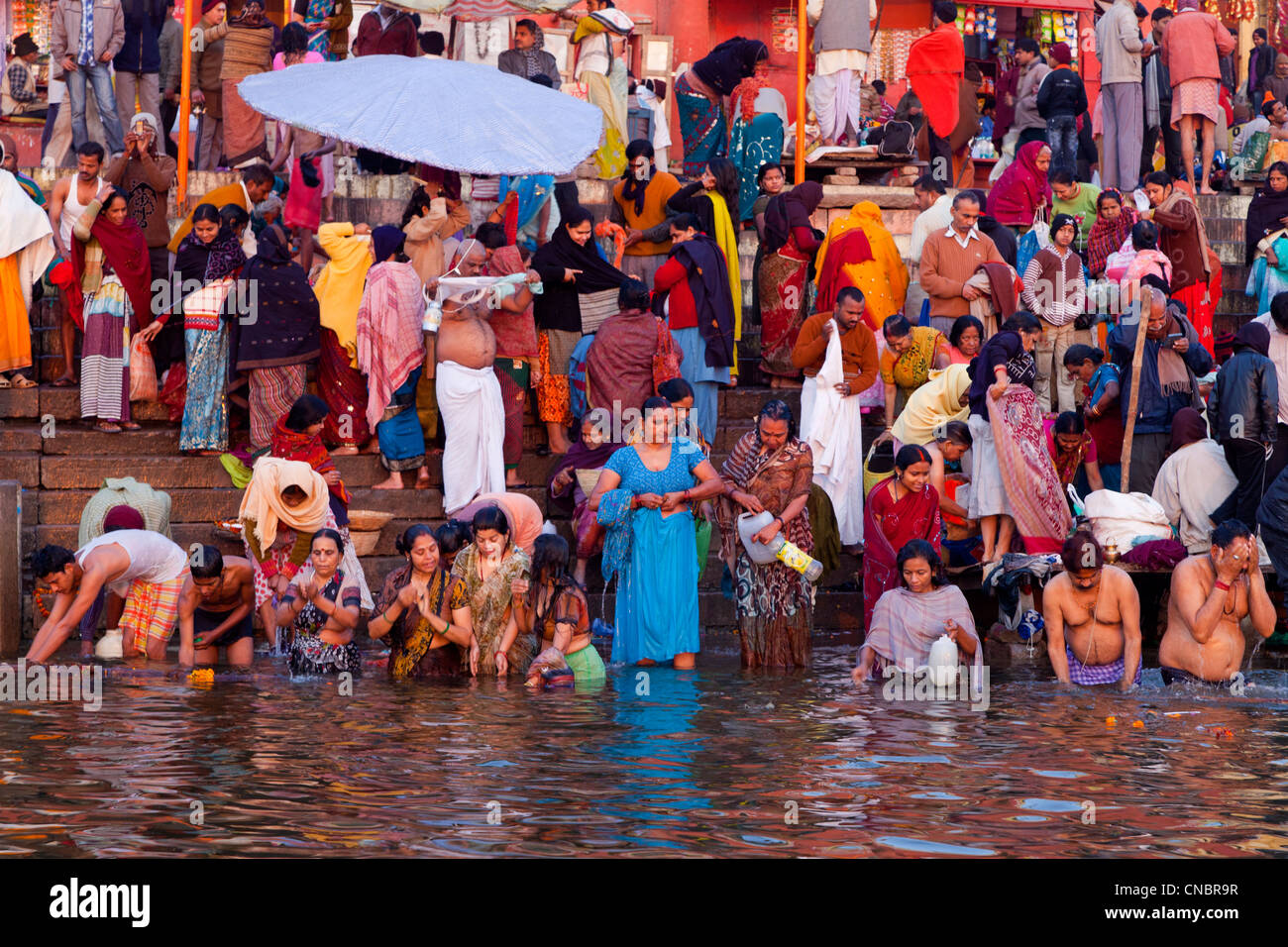 India, Uttar Pradesh, Varanasi, Pilgrims bathing and praying in the ...
