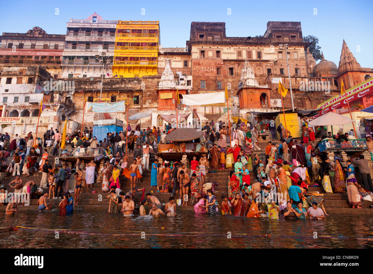 India, Uttar Pradesh, Varanasi, Pilgrims bathing and praying in the ...