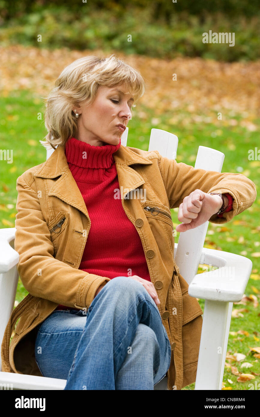 Woman looks at her watch hi-res stock photography and images - Alamy