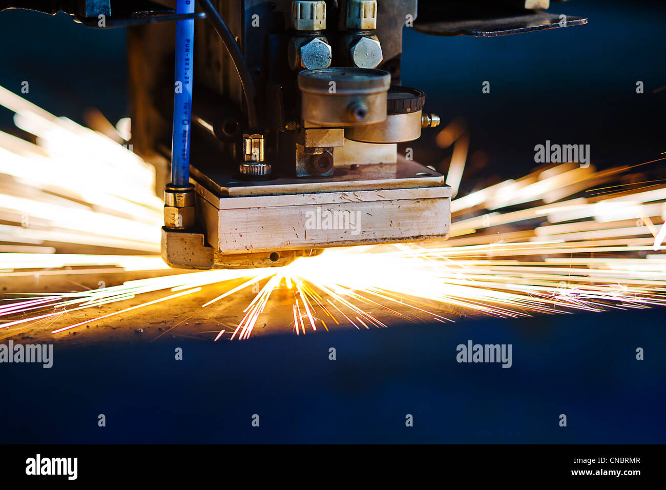 Laser cutting with sparks close up Stock Photo - Alamy