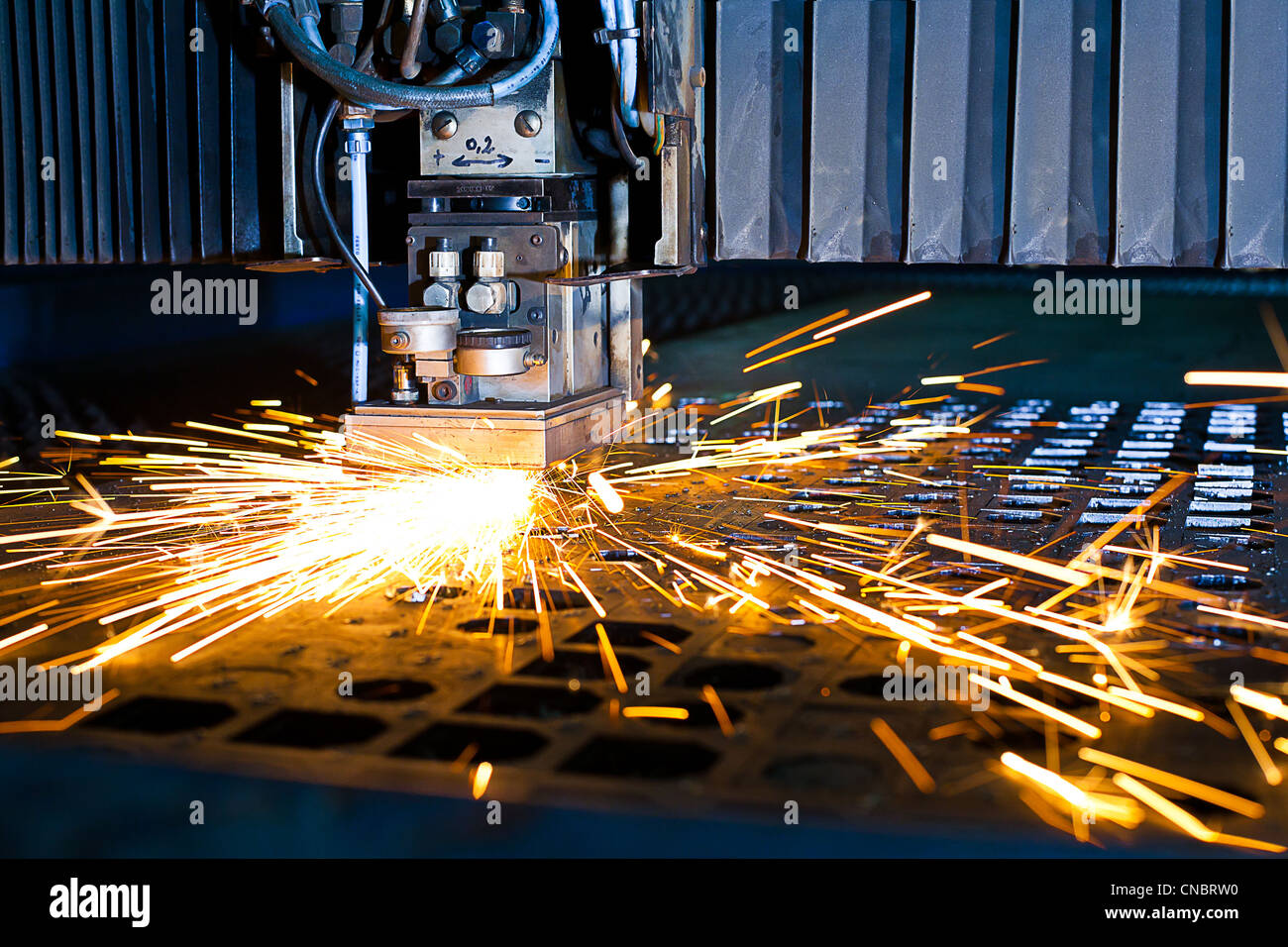 Laser cutting with sparks close up Stock Photo - Alamy