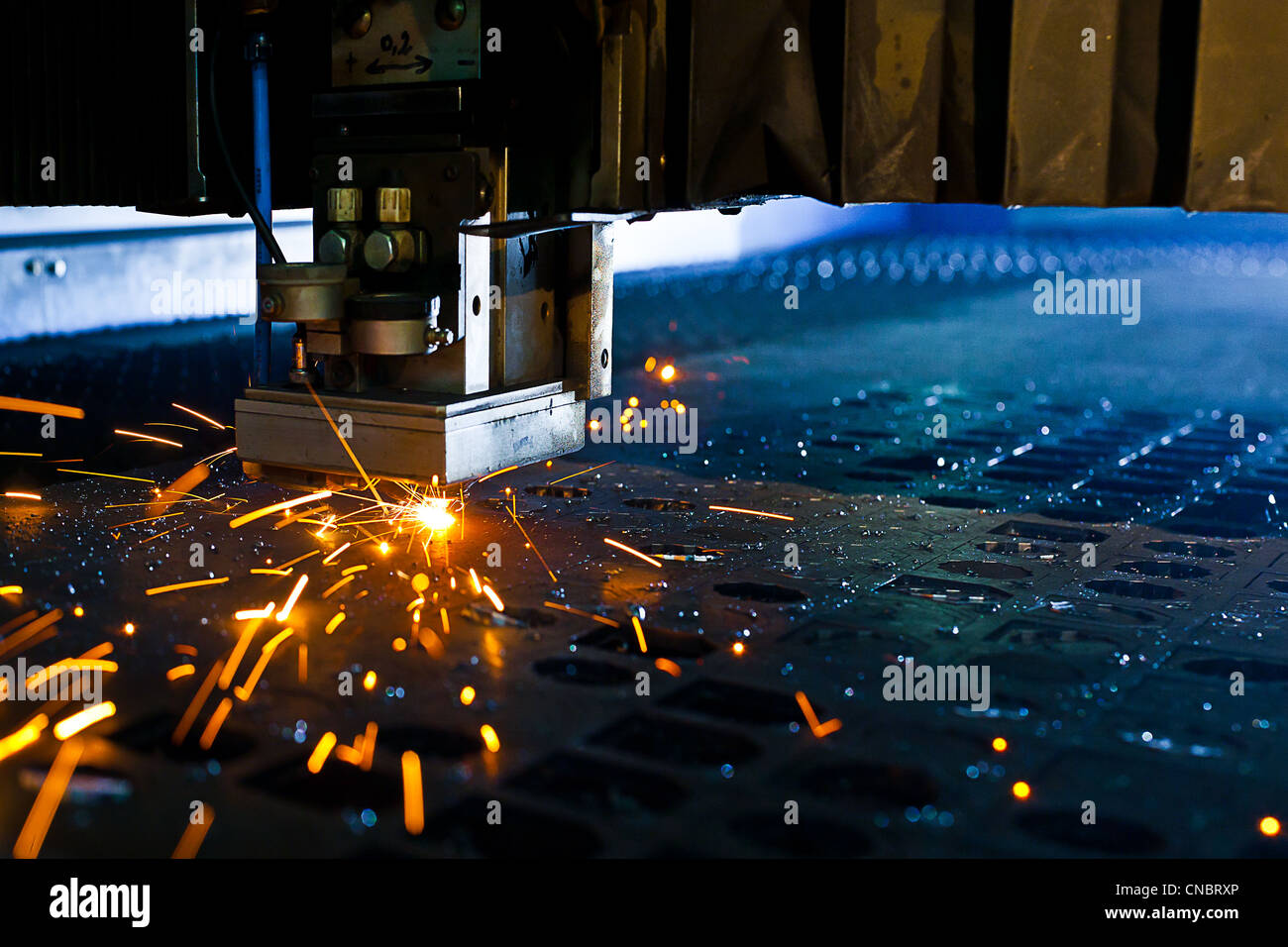Laser cutting with sparks close up Stock Photo - Alamy