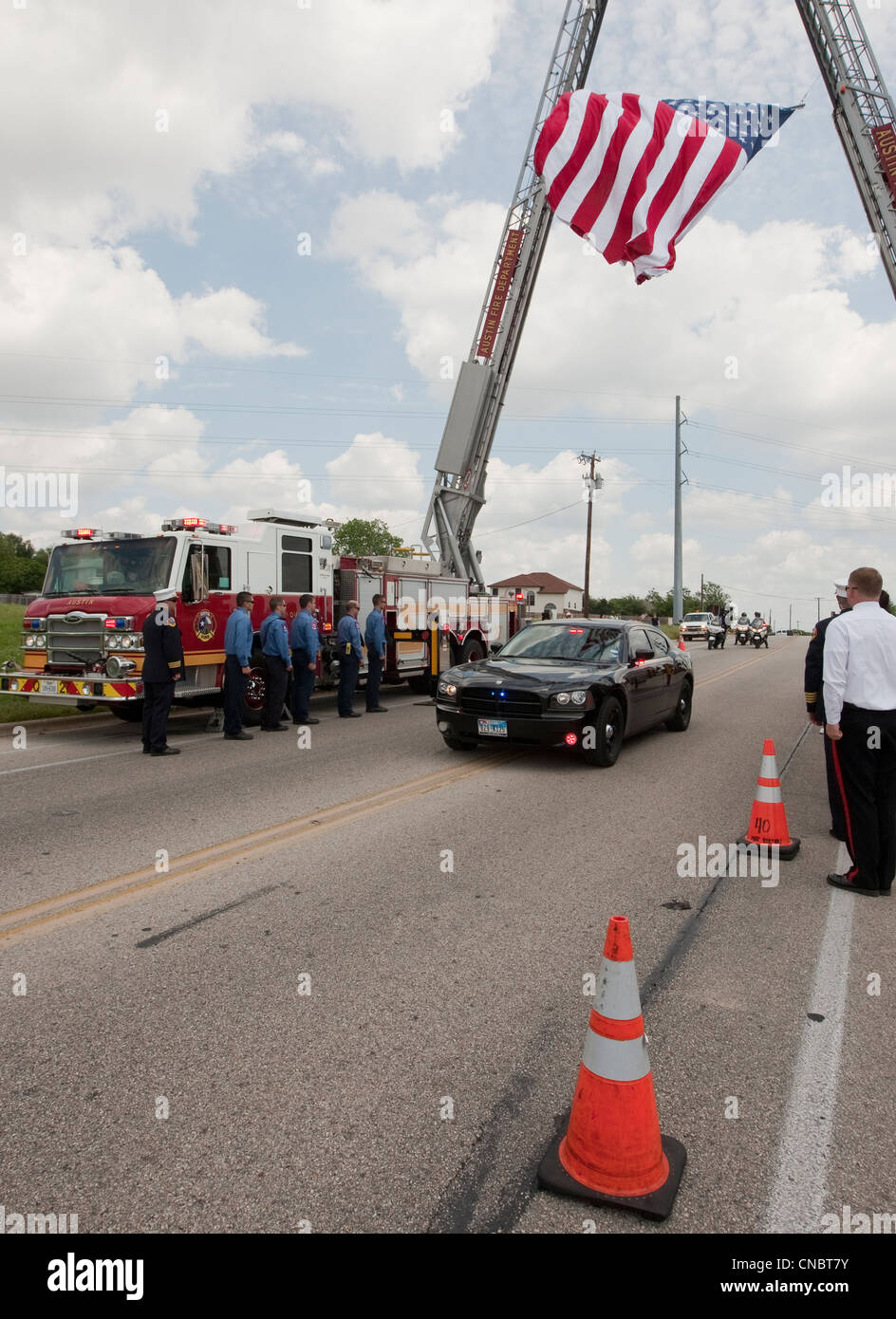 Firefighters salute as patrol car drives by during funeral procession ...