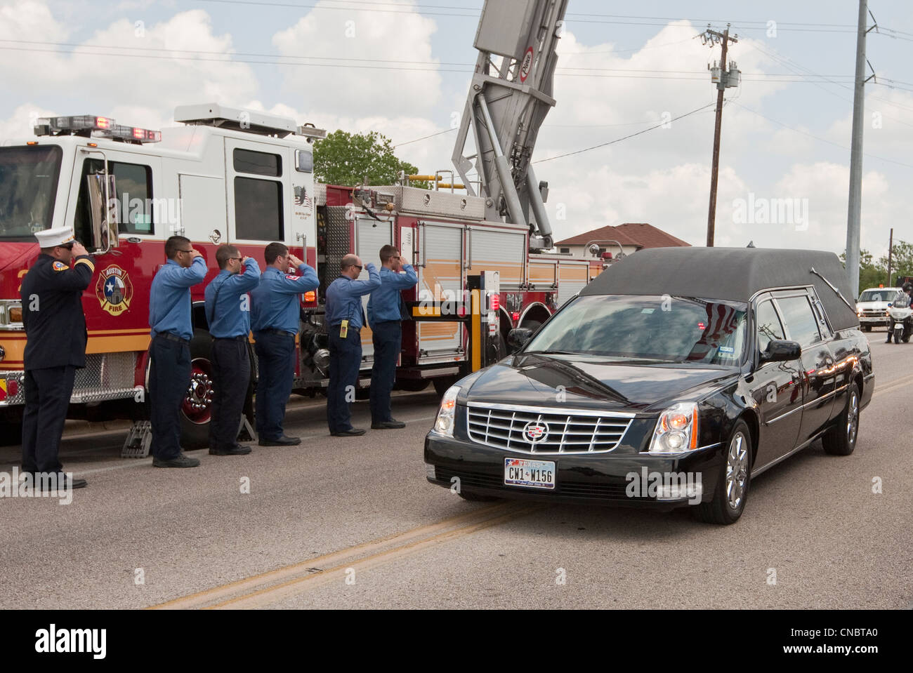 Firefighters salute as hearse drives by during funeral procession for ...