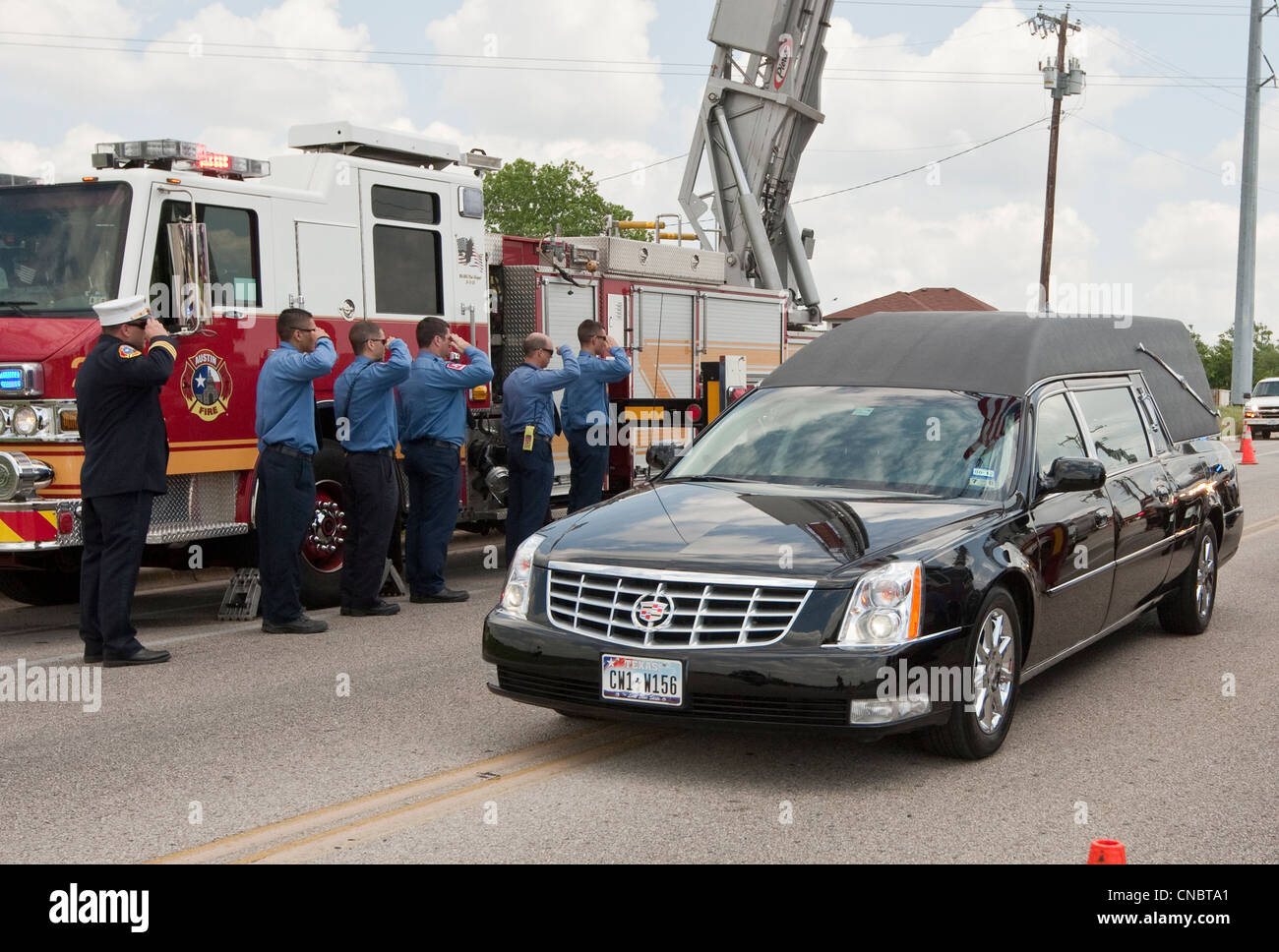 Firefighters salute as hearse drives by during funeral procession for ...