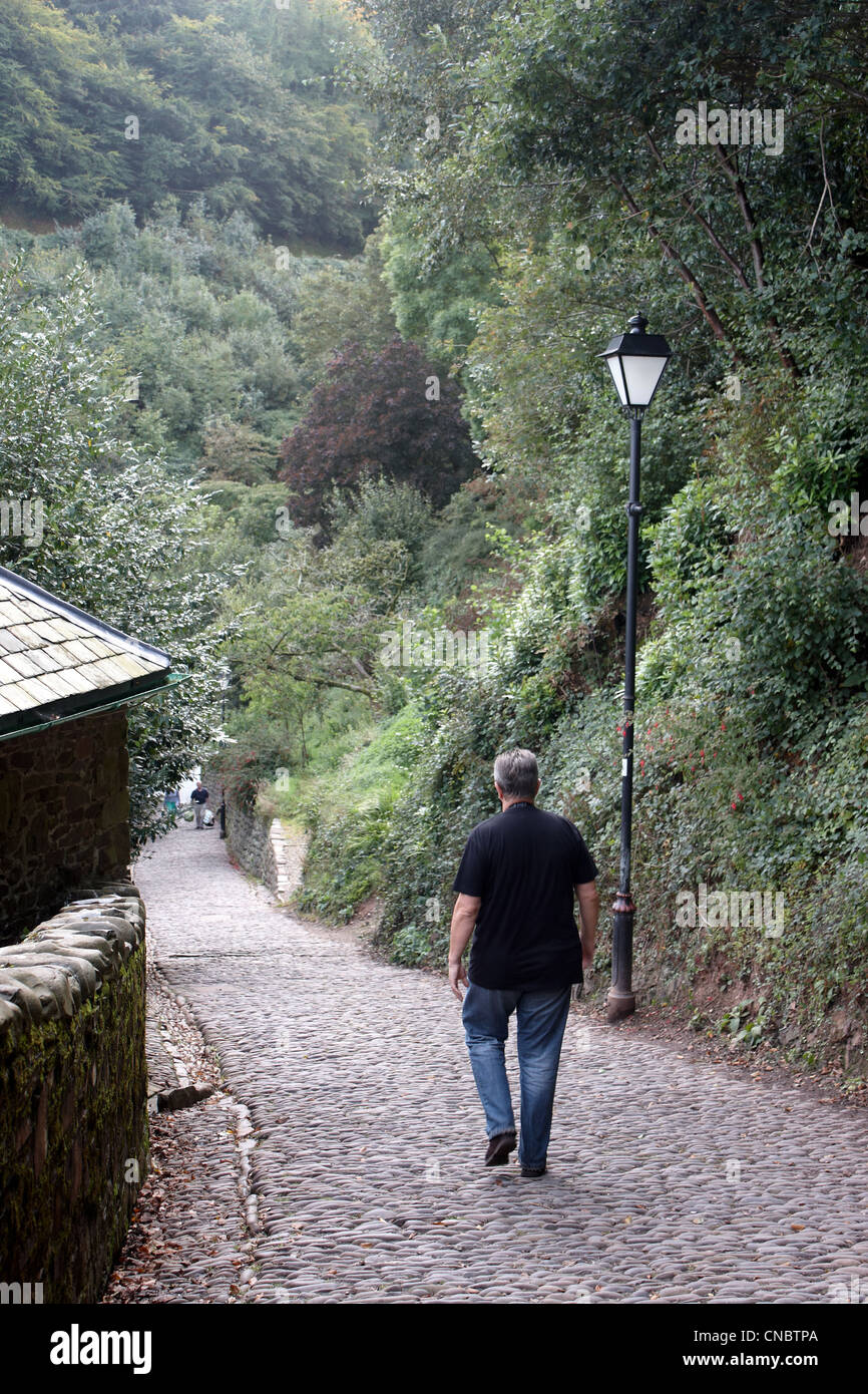 A man strolling down a cobbled path Stock Photo - Alamy