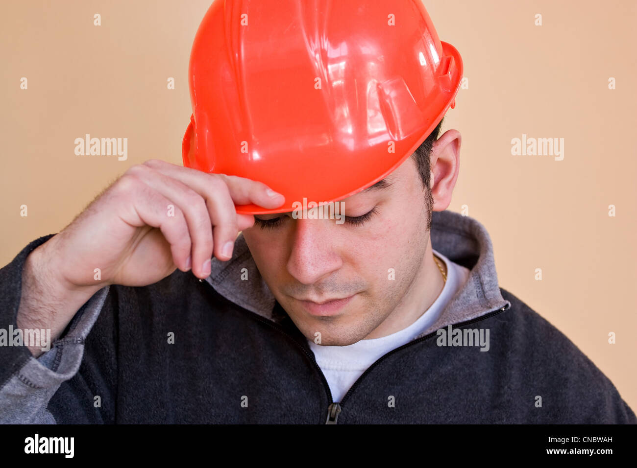A young construction professional tips putting on his hard hat Stock ...
